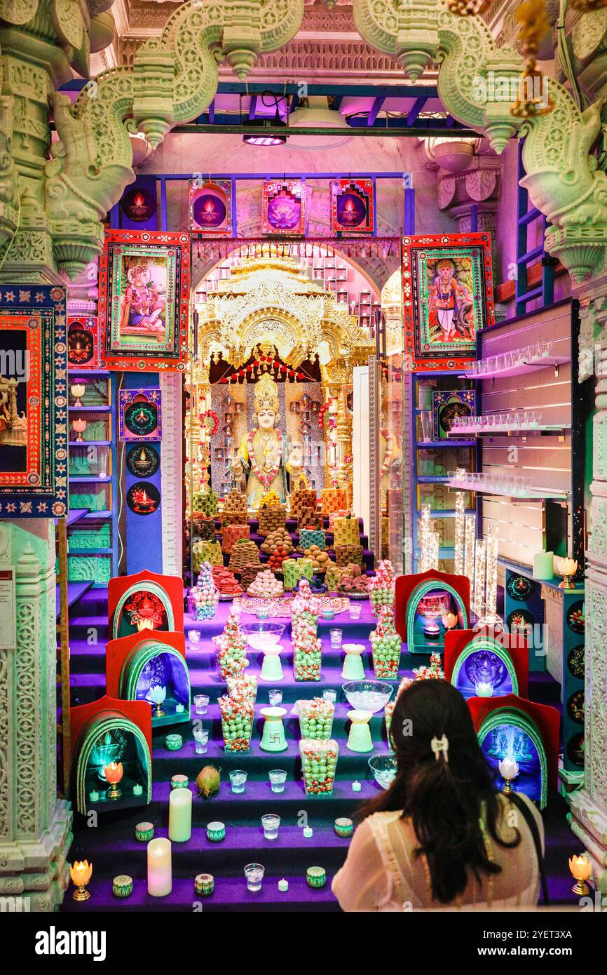 London, UK. 31st Oct, 2024. A woman pays her respects at the shrine in ...