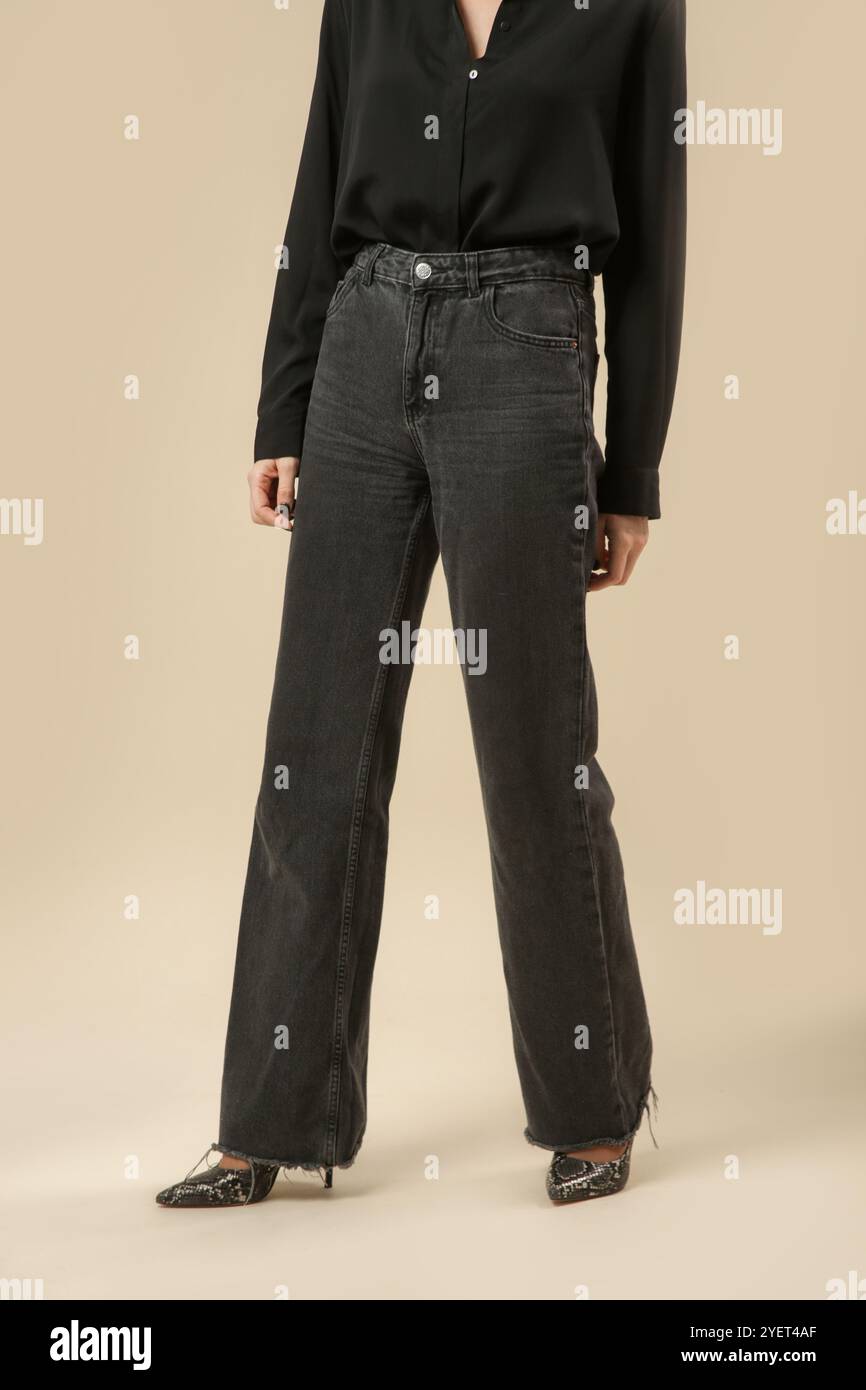 Serie of studio photos of woman in classic smart casual outfit - black denim trousers, black ...
