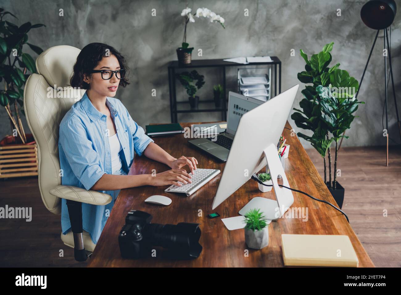 Portrait of young lady photographer write keyboard desk loft interior ...