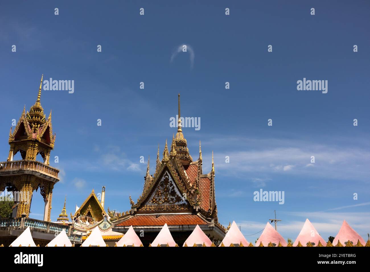 Traditional Thai temple architecture with intricate gold details under ...
