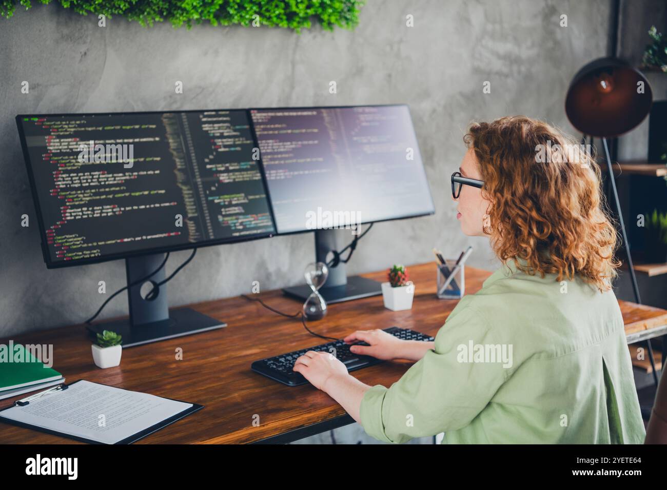 Profile photo of young hacker programmer girl typing keyboard wear shirt workstation loft office ...