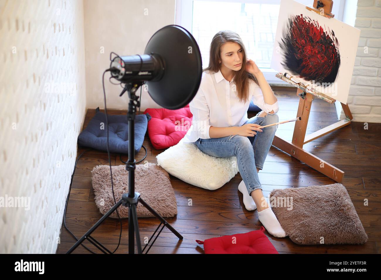 Beautiful girl artist at work in a creative white studio Stock Photo ...
