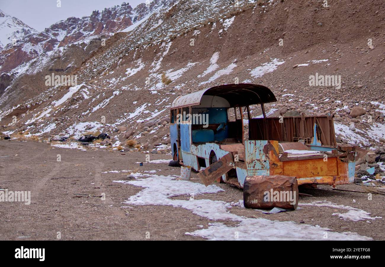old rusty bus broken down in disuse in the middle of mountains with ...