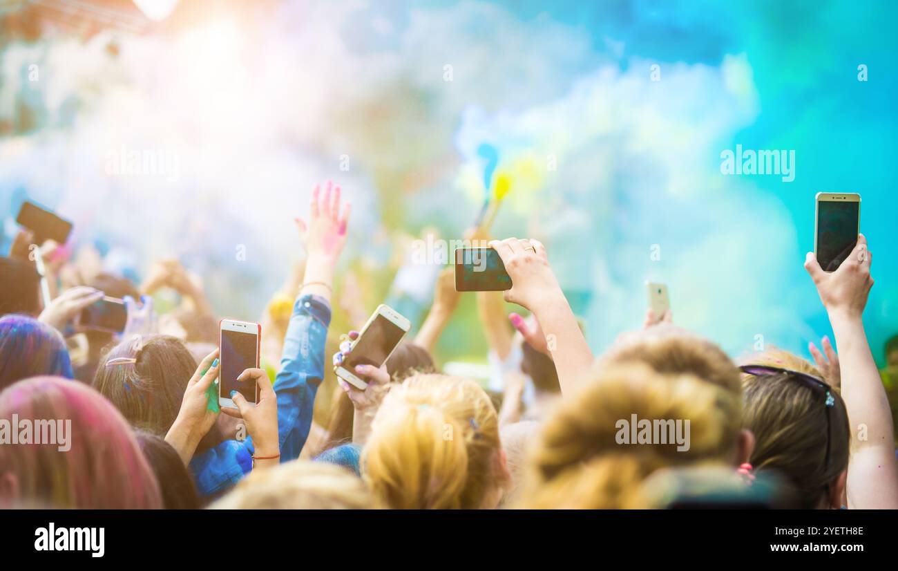 Crowd of people dancing and celebrating Holi festival of colors. People ...