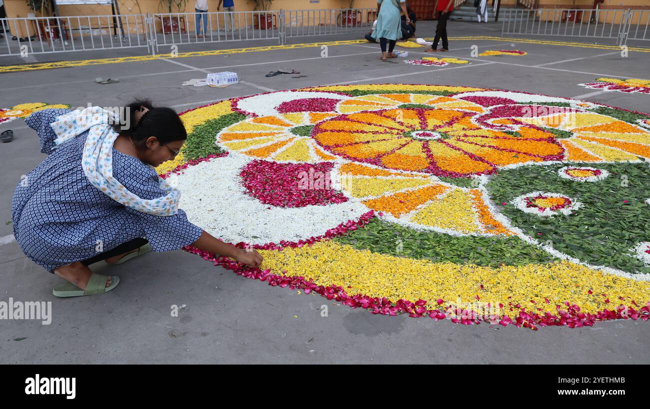 Women creating rangoli patterns from the petals of flowers, to ...