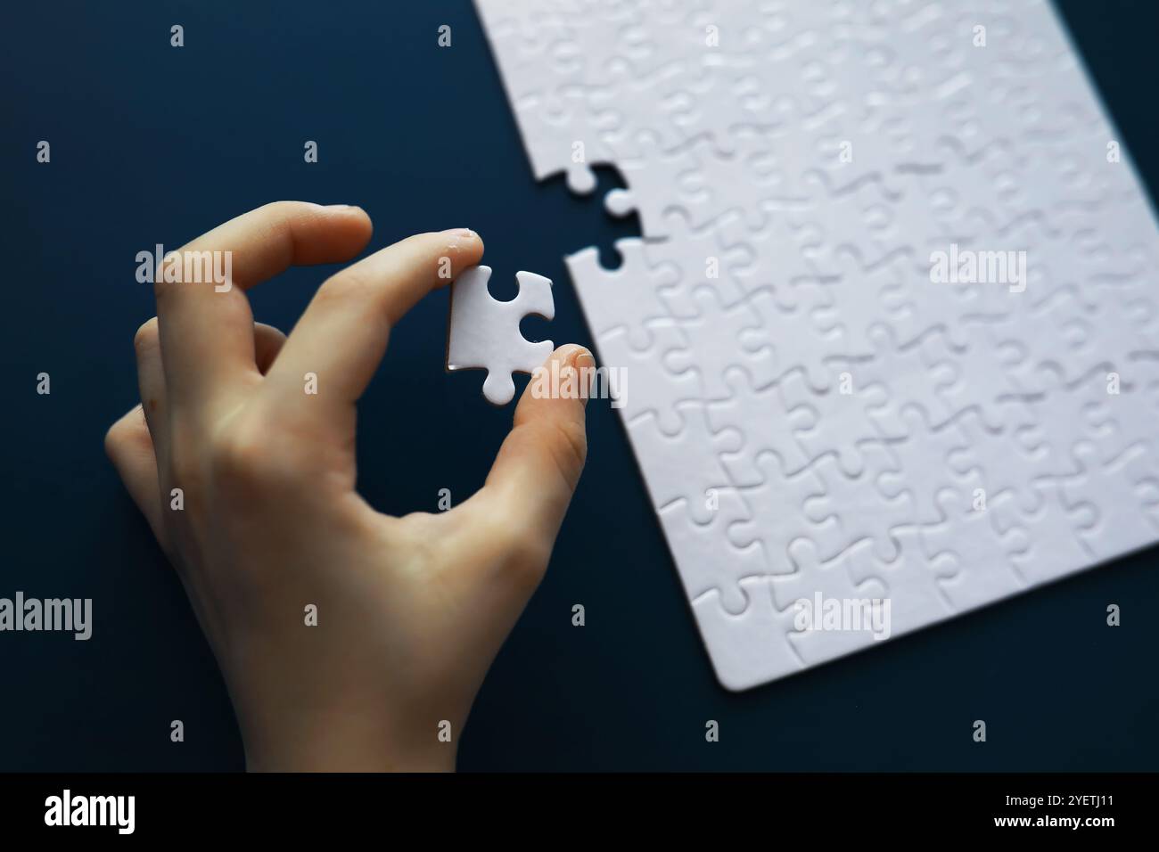 Intellectual puzzles. The puzzle empty. The hand puts together puzzle ...