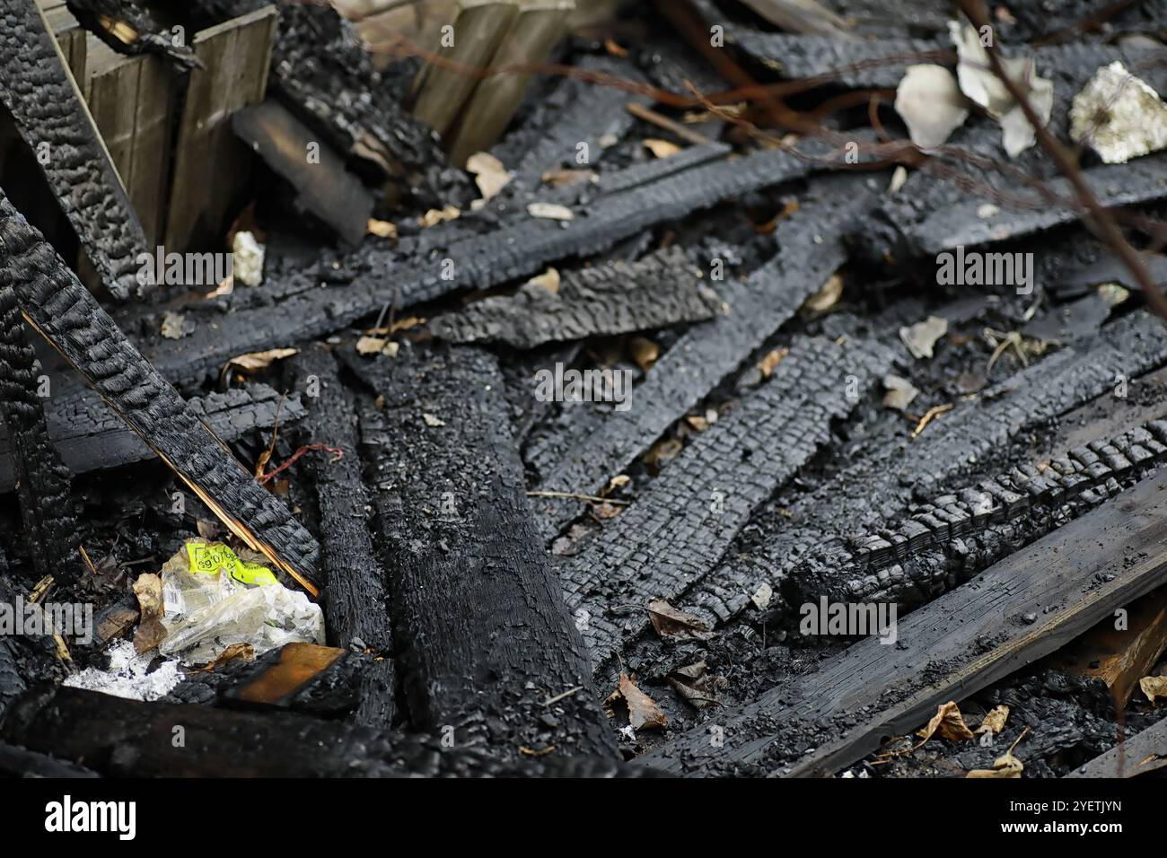 Wooden house after the fire. Coals on the logs. The ashes of the house ...
