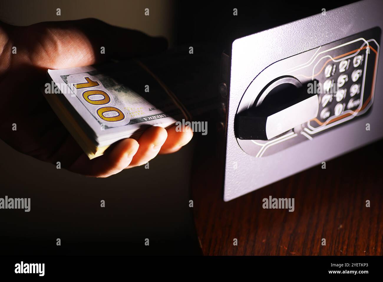 Steel safe with money. Hand putting password in the safety money box in ...