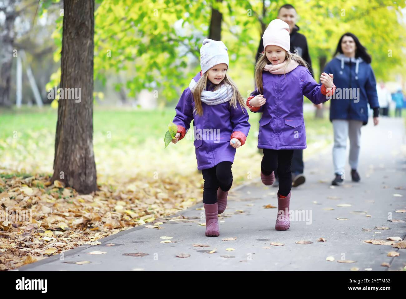 Children for a walk in autumn park. Leaf fall in the park. Family. Fall ...