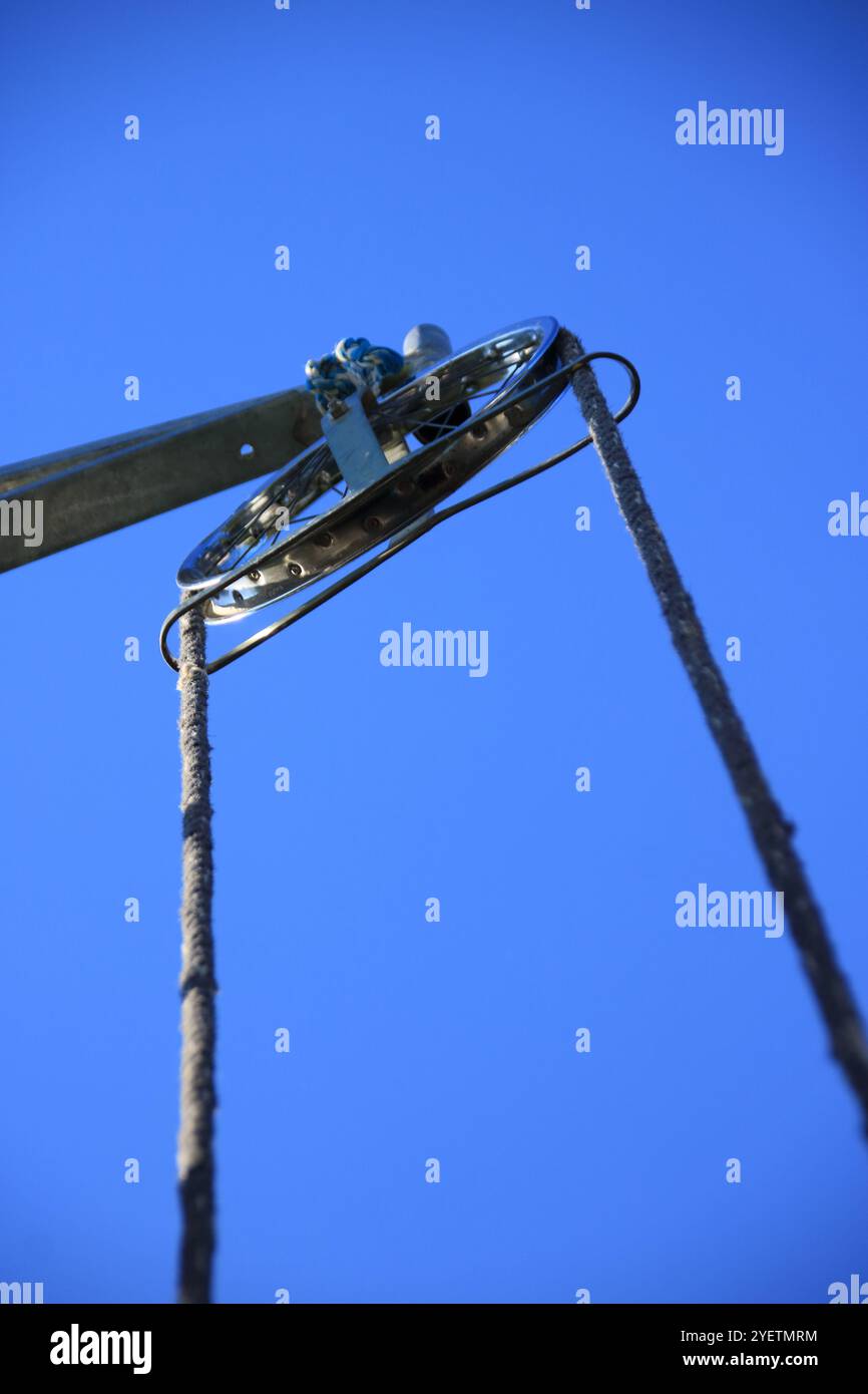 Round pulley with rope for lifting a load on a construction site Stock ...