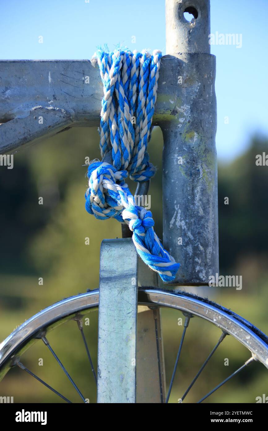 Round roller on a construction site is attached to a carrier with a ...