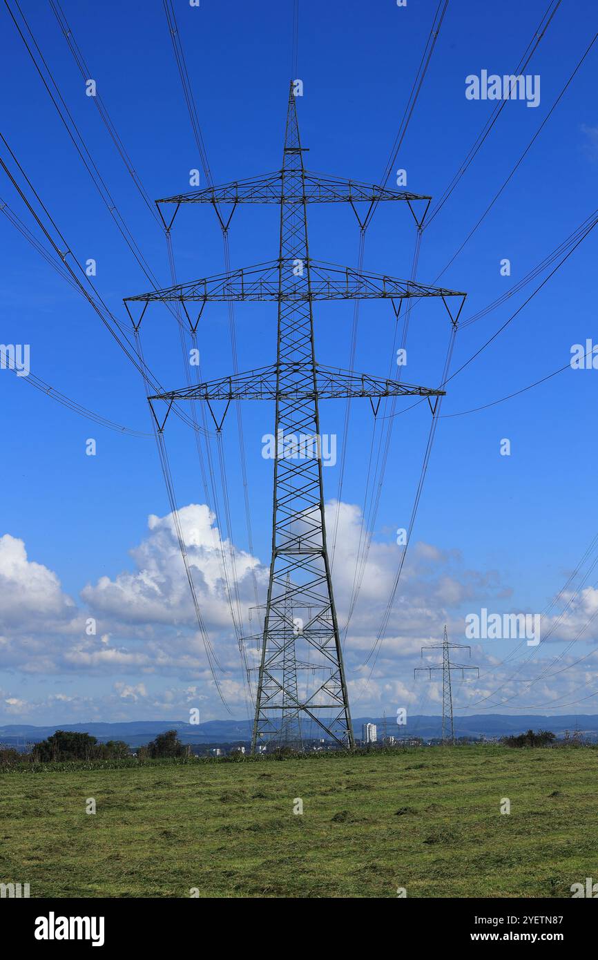 High voltage pylon against a blue sky Stock Photo - Alamy