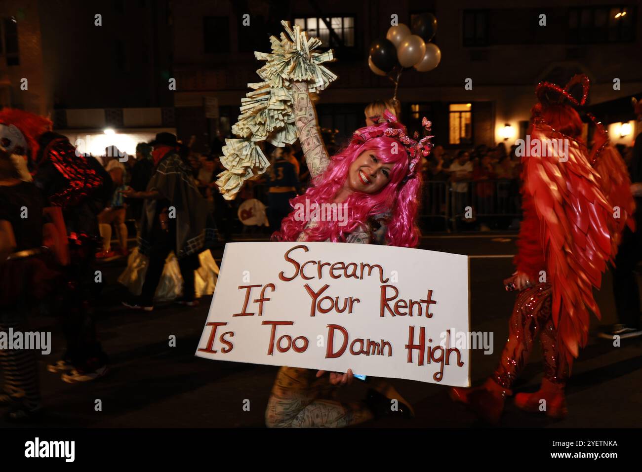 A reveler hold up signs during the New York’s 51st Annual Village ...