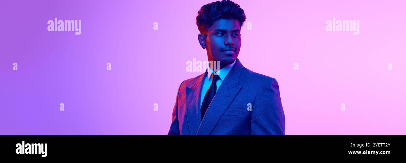 Portrait of young Indian man in formal wear, looking confidently aside ...