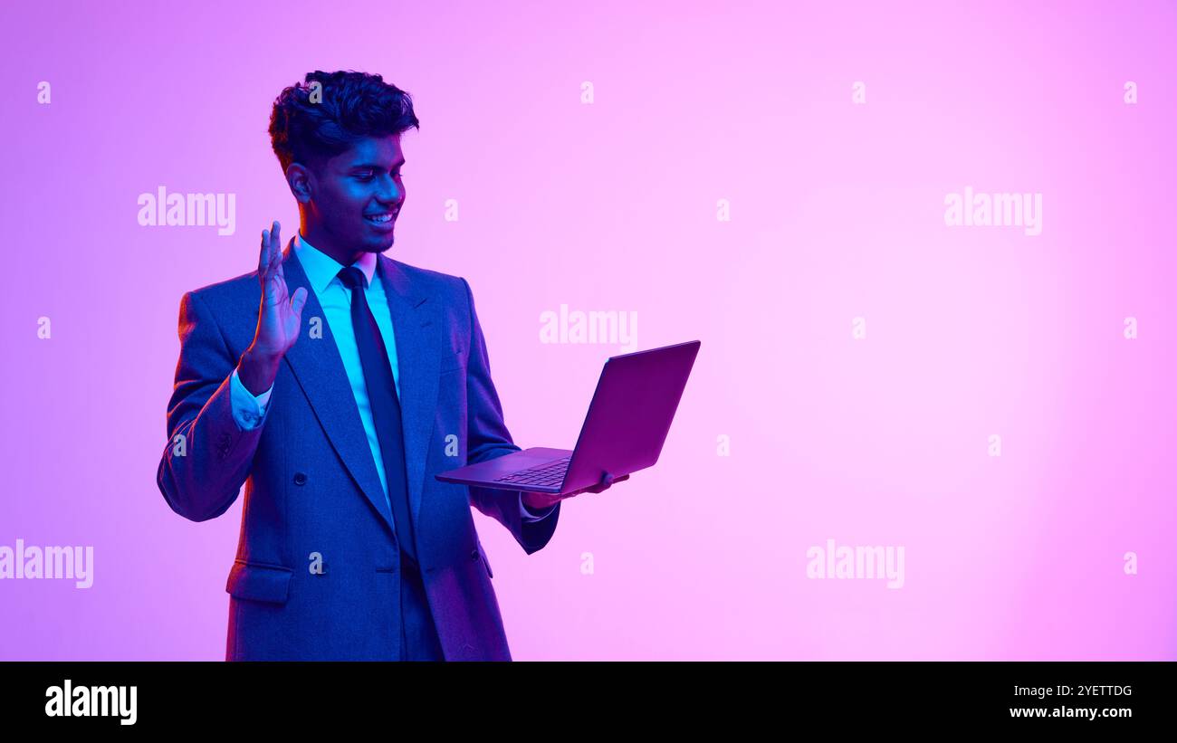 Portrait of young smiling Indian man in formal wear holding laptop and ...