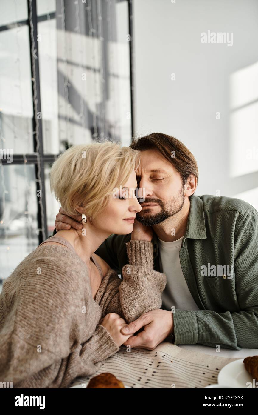 A couple cherishes a tender embrace at their home while relaxing ...