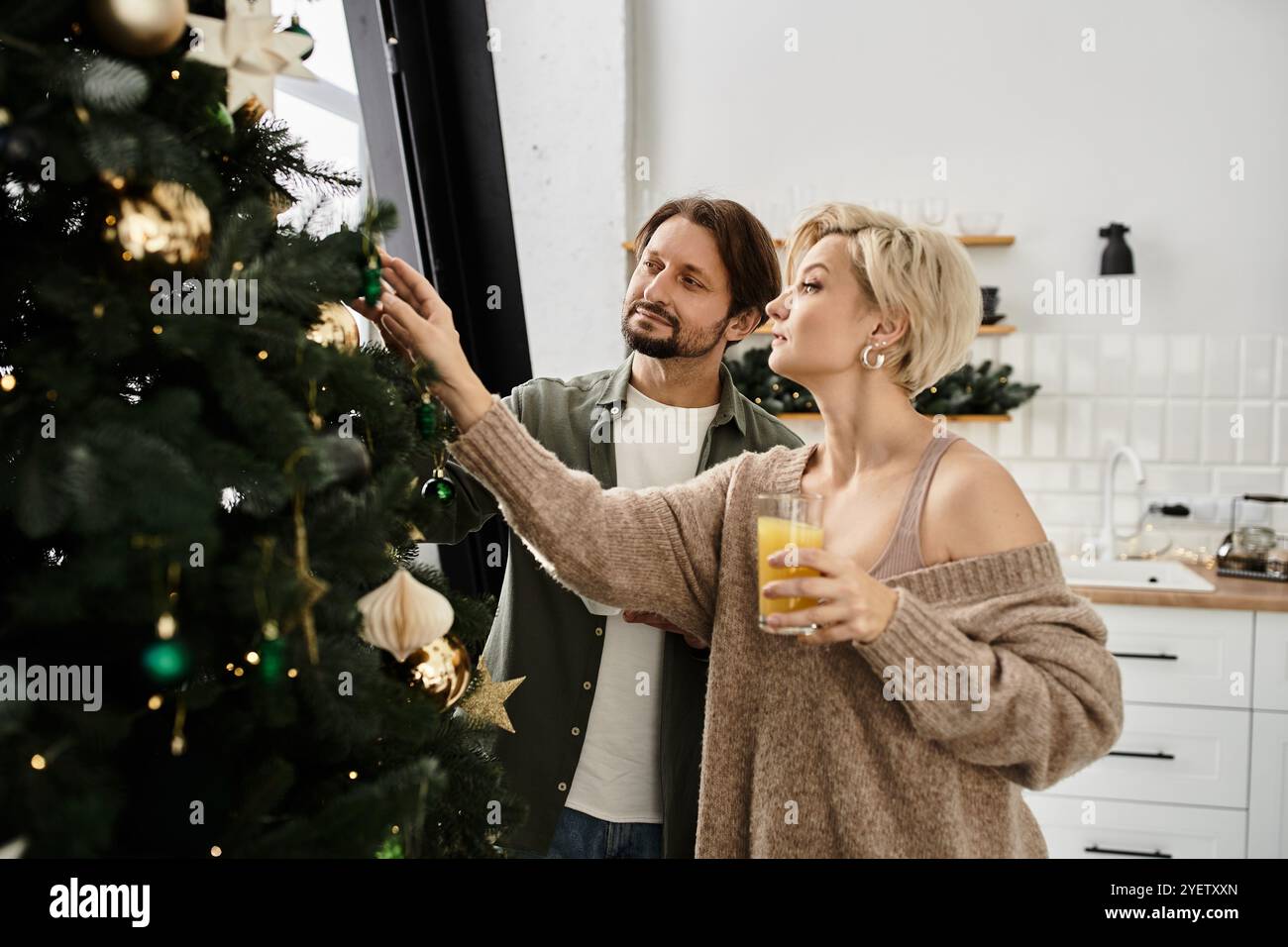 Loving family decorates christmas tree hi-res stock photography and ...