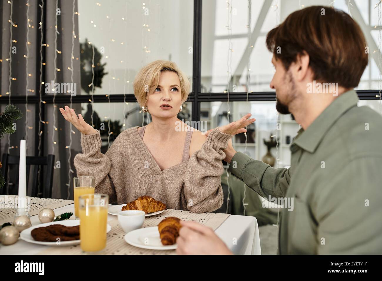 A couple shares a warm breakfast at home, filled with smiles and lively ...