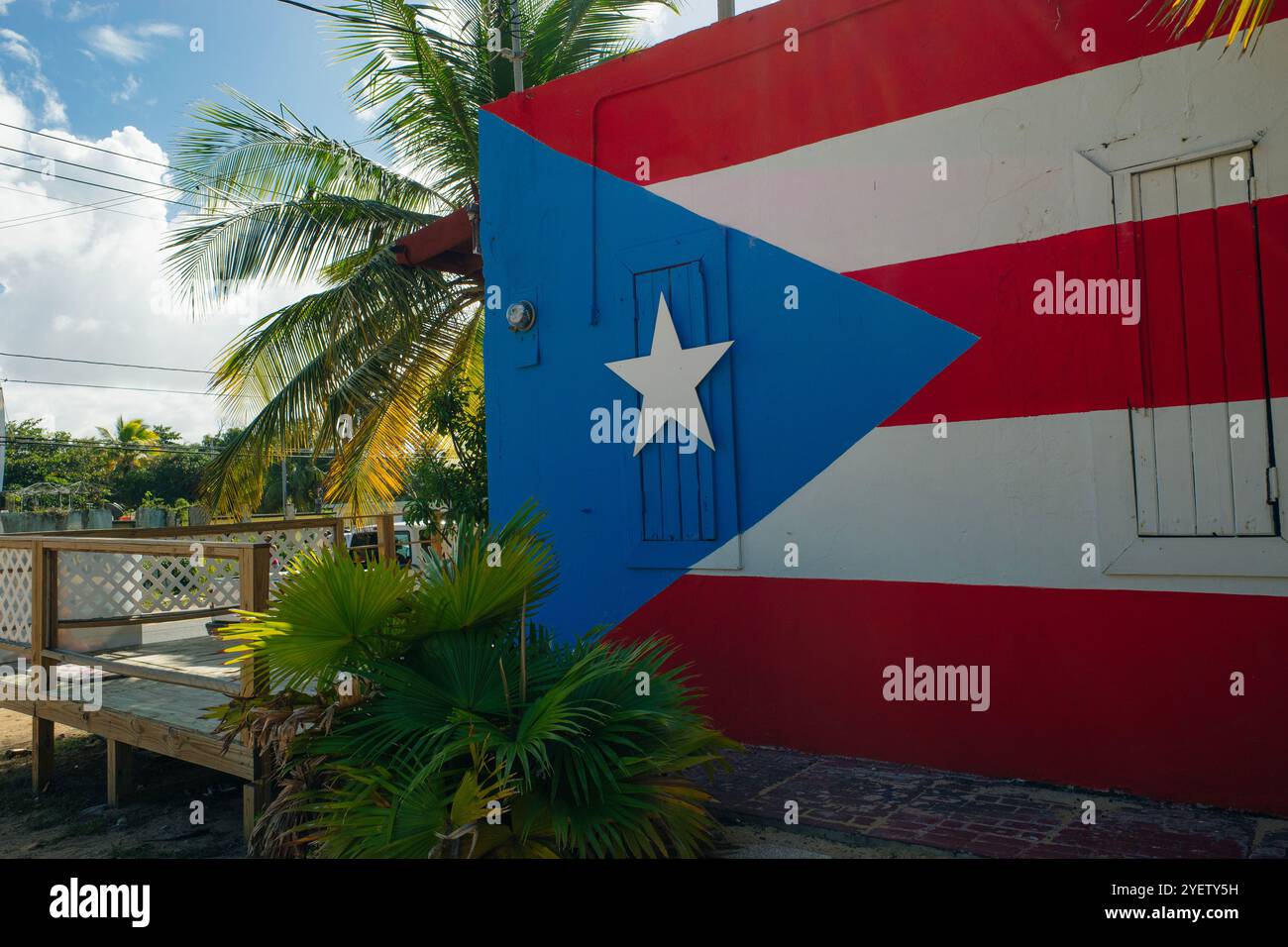 Puerto Rico flag on building with palm trees in background. High ...