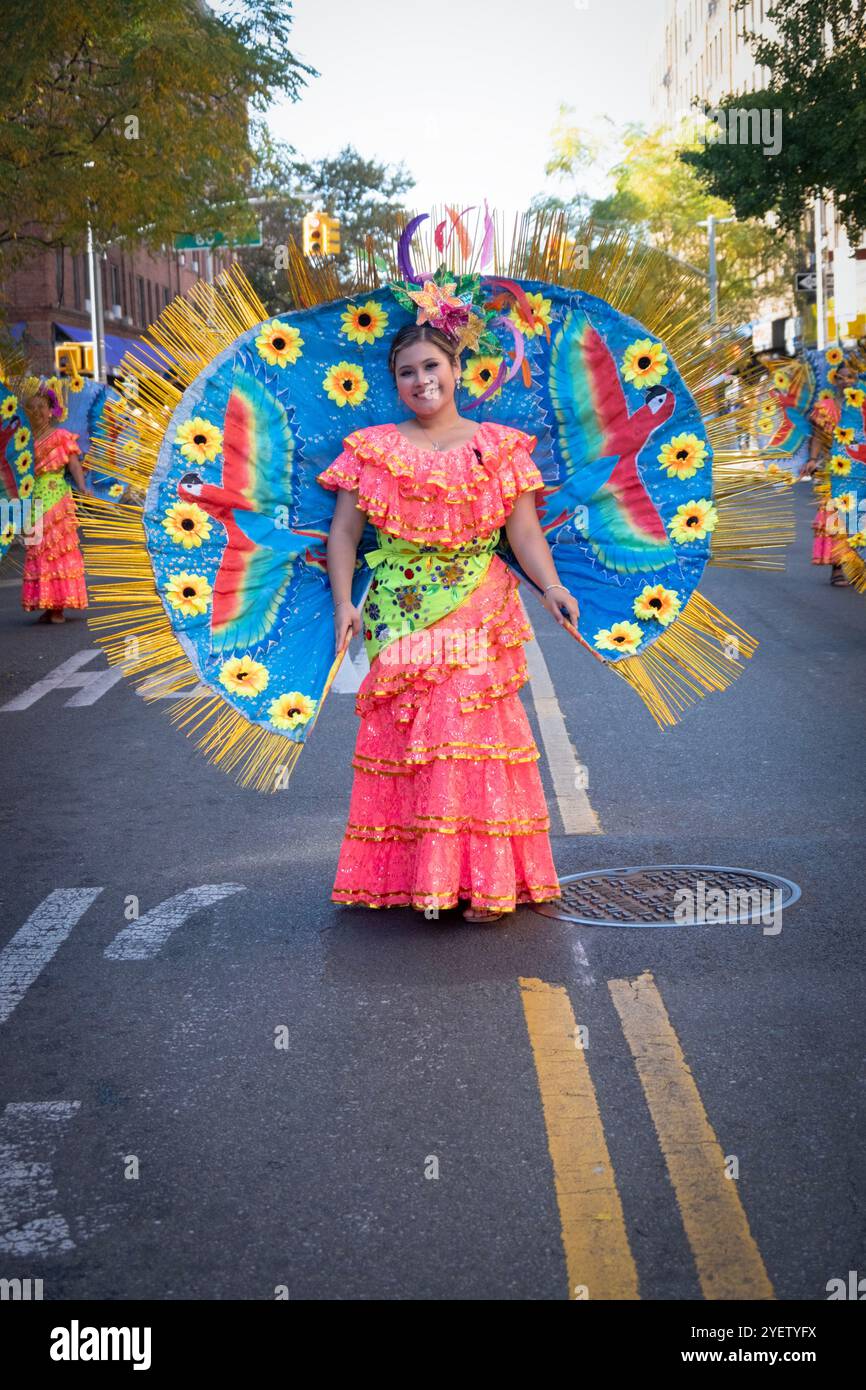 A pretty South American woman in an orange dress and fancy backdrop. At ...