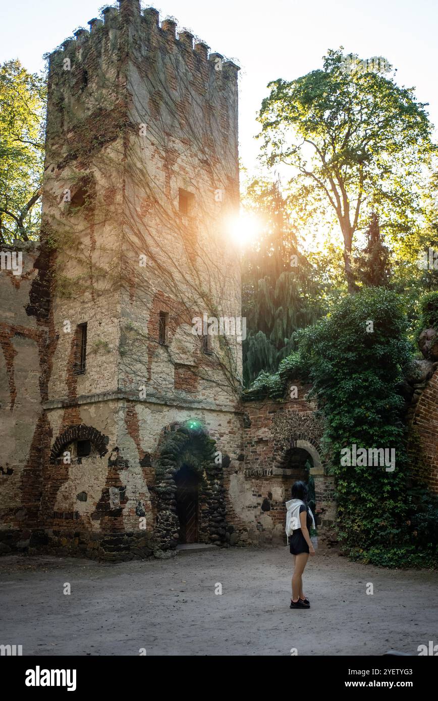 person exploring ruins of ancient old castle, woman tourist watching ...