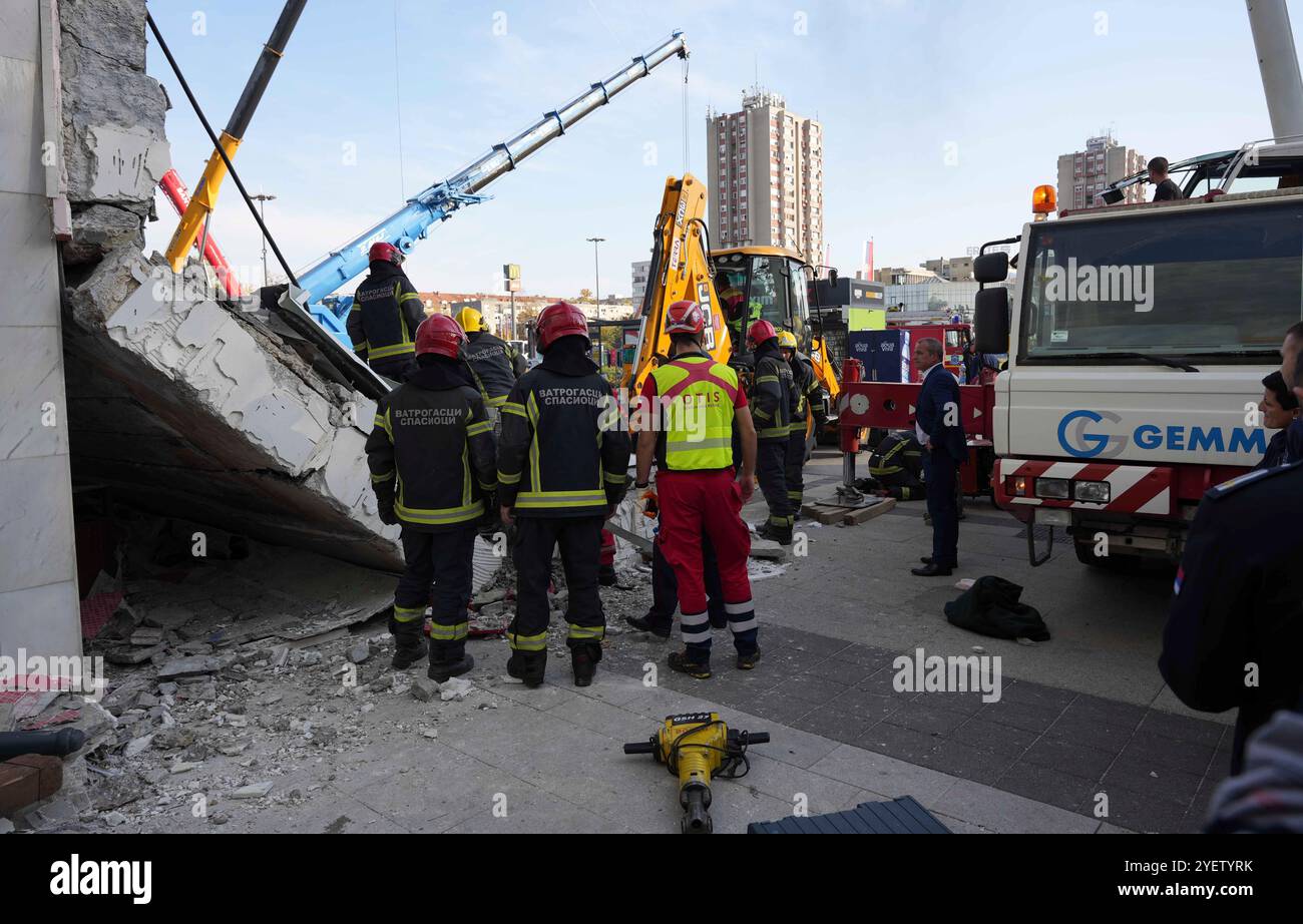 Rescue service workers inspect a scene as a roof collapsed at a railway ...