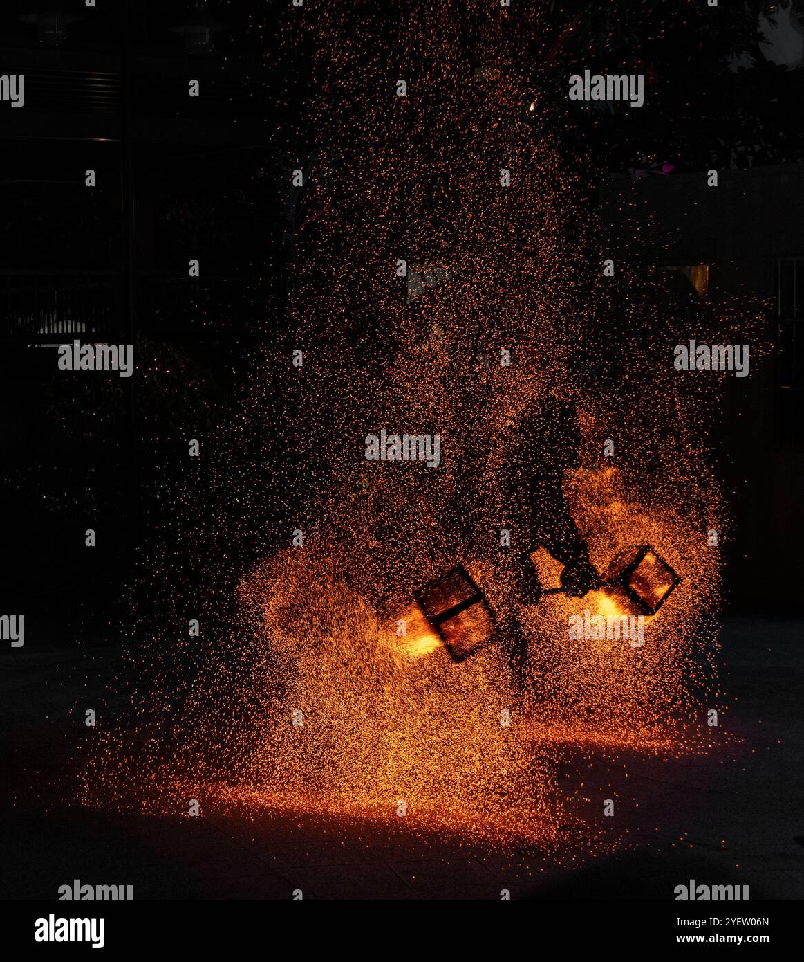 Fire pot performance showcasing a performer manipulating a fiery iron ...