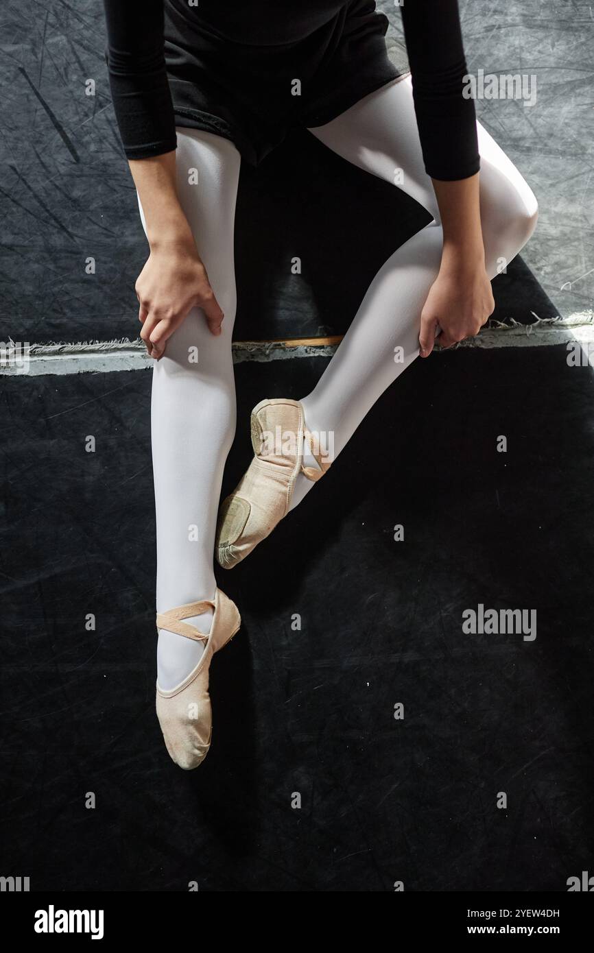 Vertical shot of unrecognizable female dancer wearing ballet slippers ...
