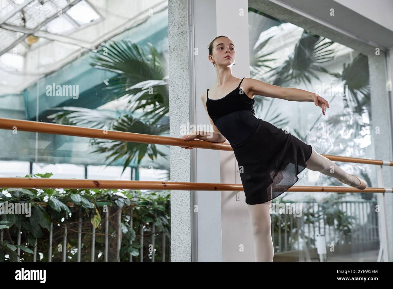 Confident teenage ballet dancer gracefully performing Arabesque ...