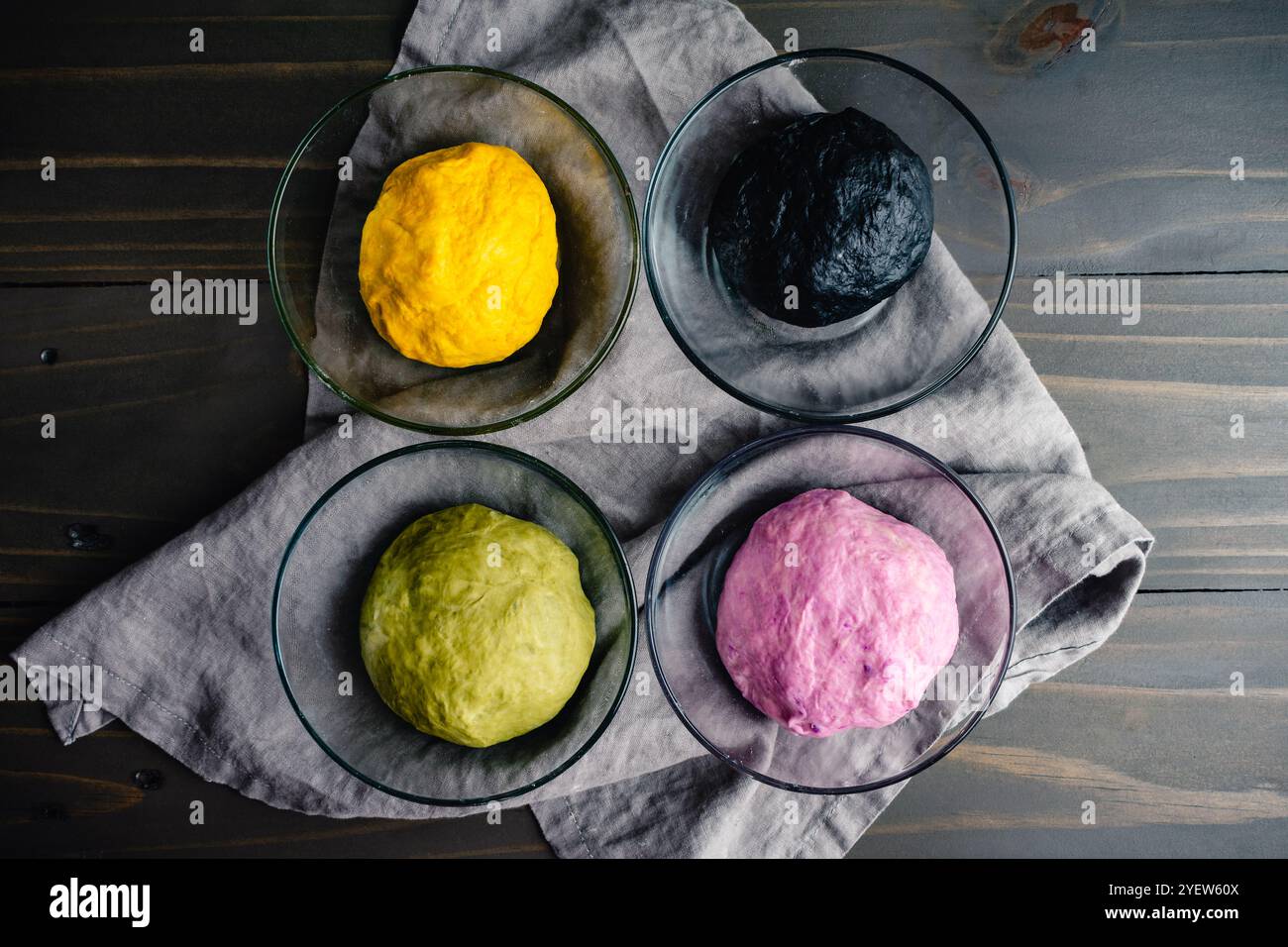 Colorful Balls of Kneaded Bread Dough in Glass Bowls: Yellow, black ...