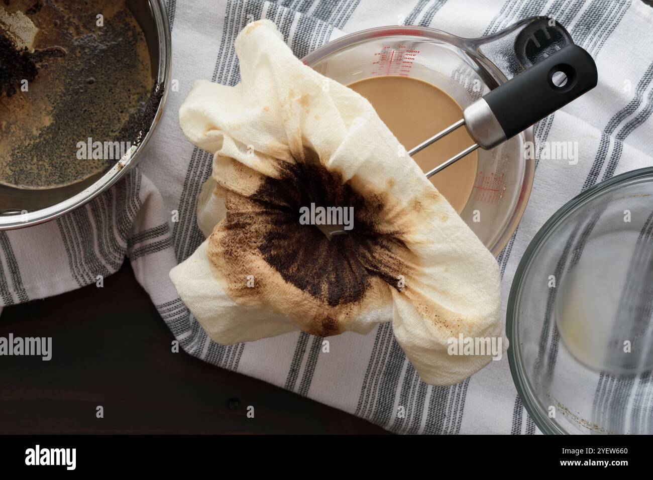 Straining Coffee Grounds from Warmed Milk and Cream through Cheesecloth ...