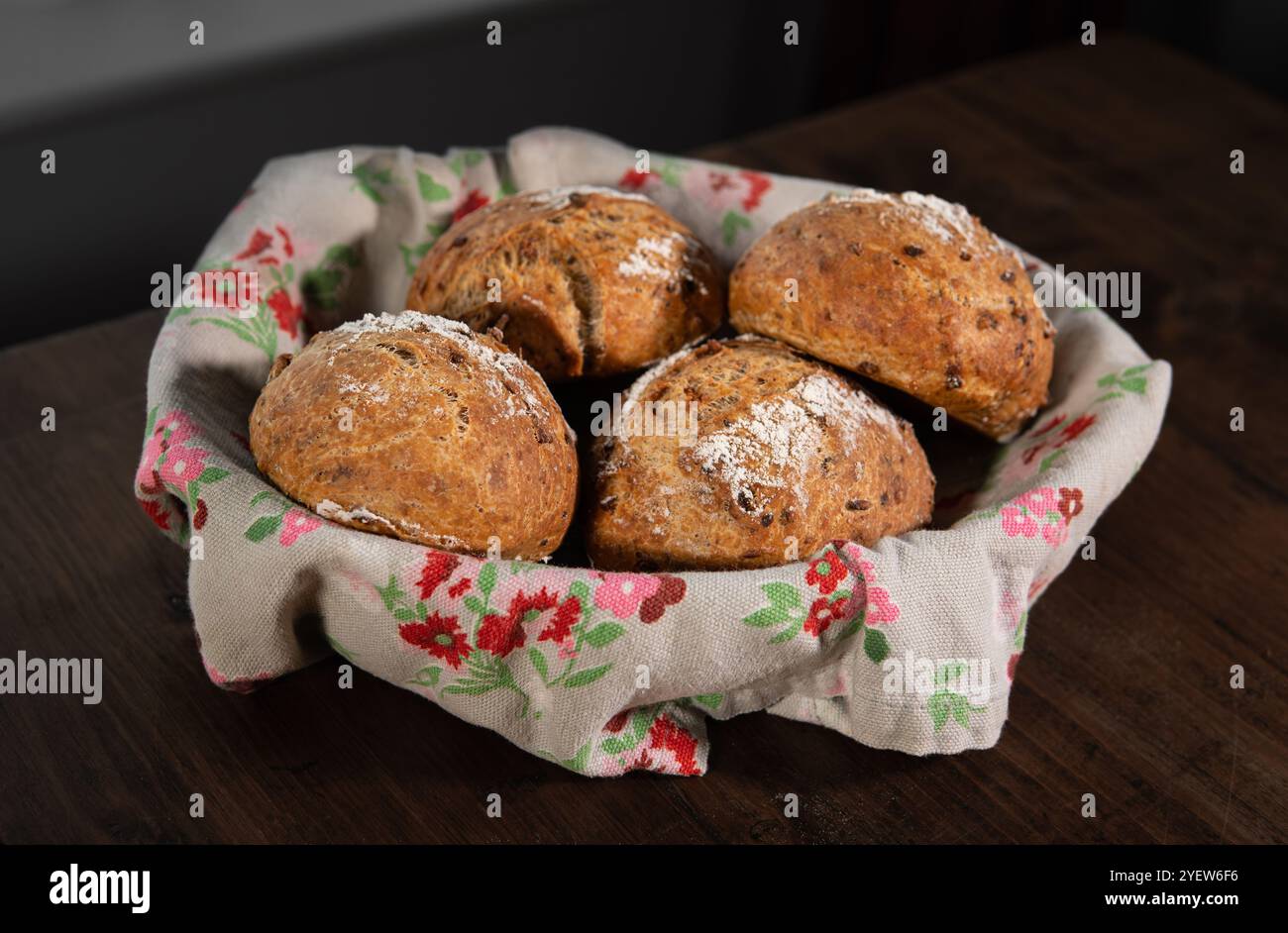 Classic farm country bread buns in a cute basket next to a mug, butter ...