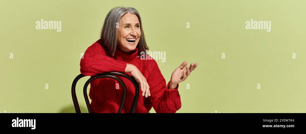 A graceful woman with grey hair smiles warmly, showcasing winter ...