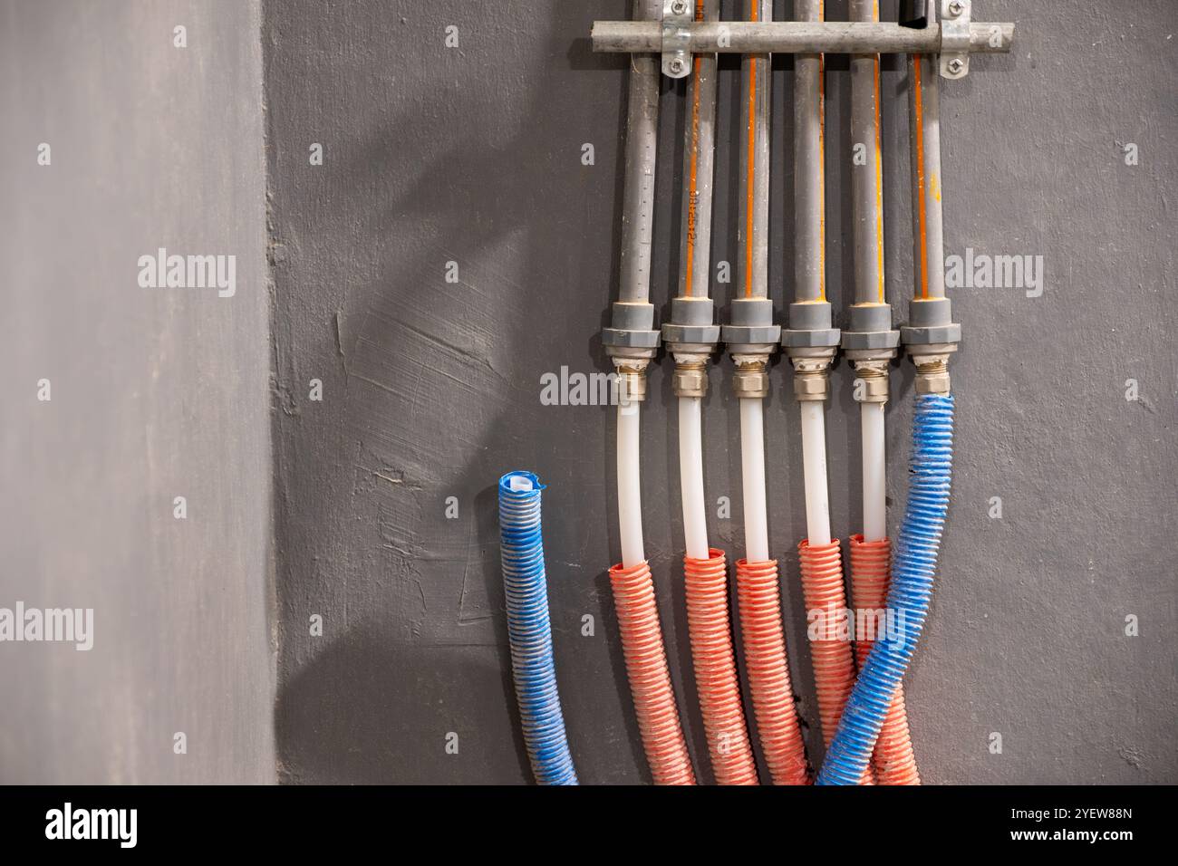 Detailed view of metal pipes installed on a wall with yellow and white ...