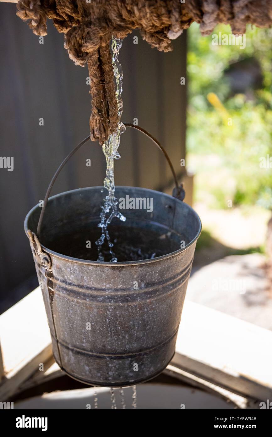 A view of a water fountain, featuring water dripping down a rope, into ...