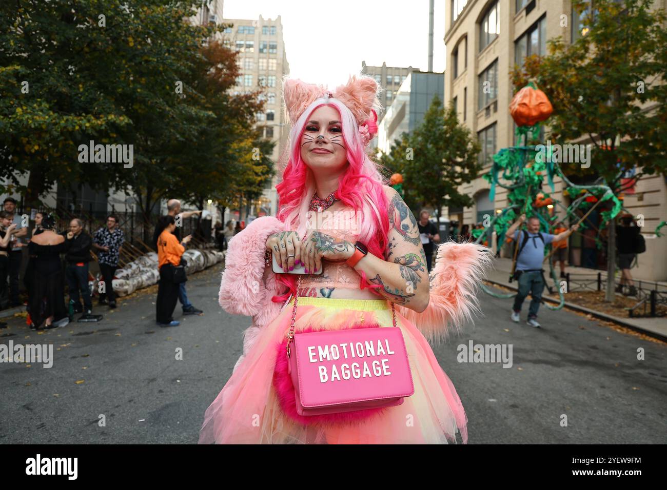A reveler is dressed as a cat with emotional baggage for the New York’s ...