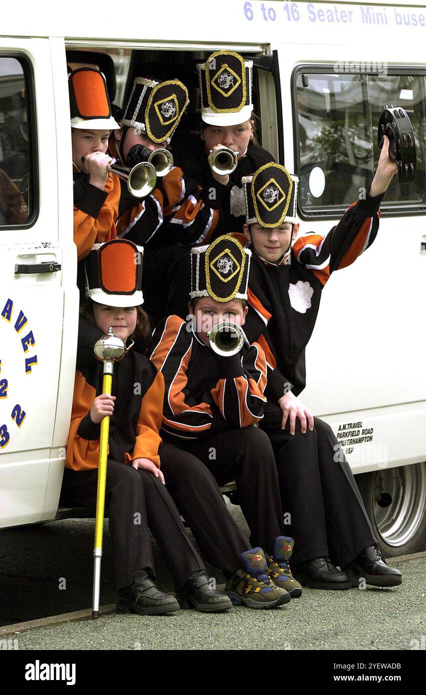 Young marching band members board their new mini bus wearing their band ...
