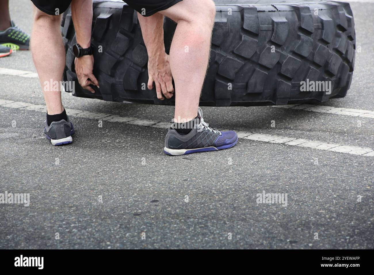 A view of a person lifting a giant tire, as an exercise routine Stock ...
