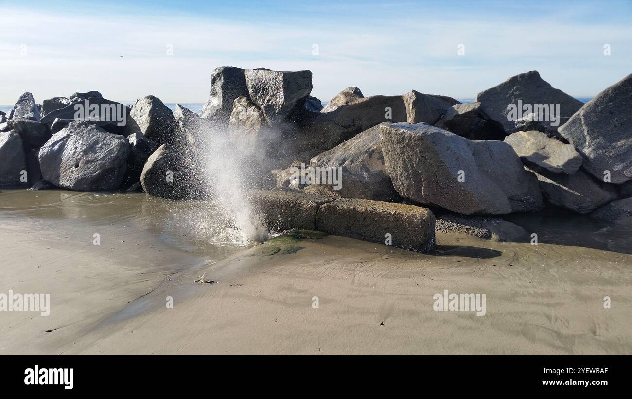 A view of a marine geyser made from rocky jetty and concrete boulders ...
