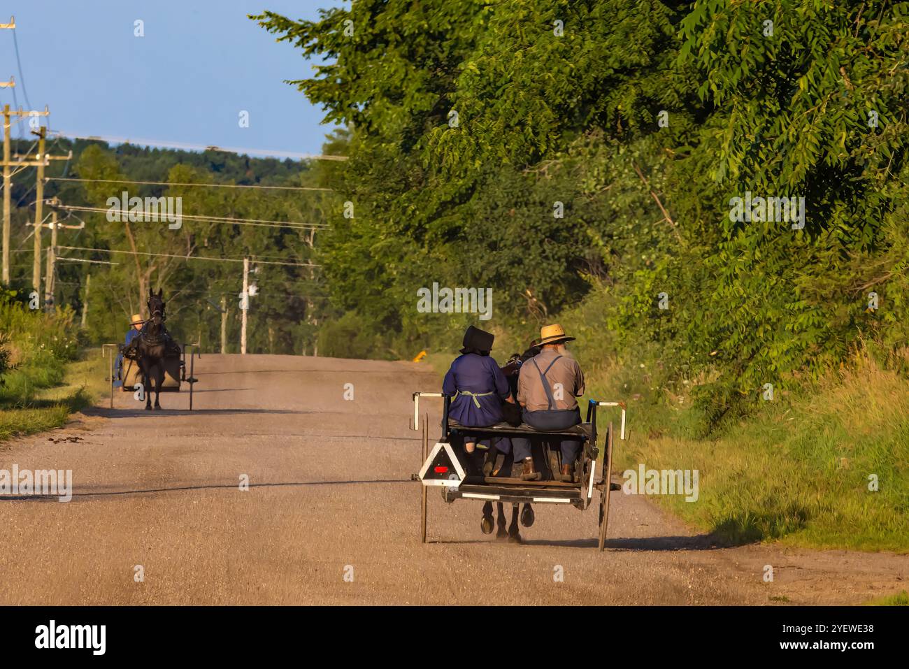 Amish buggies passing on a gravel road in Mecosta County, Michigan, USA ...