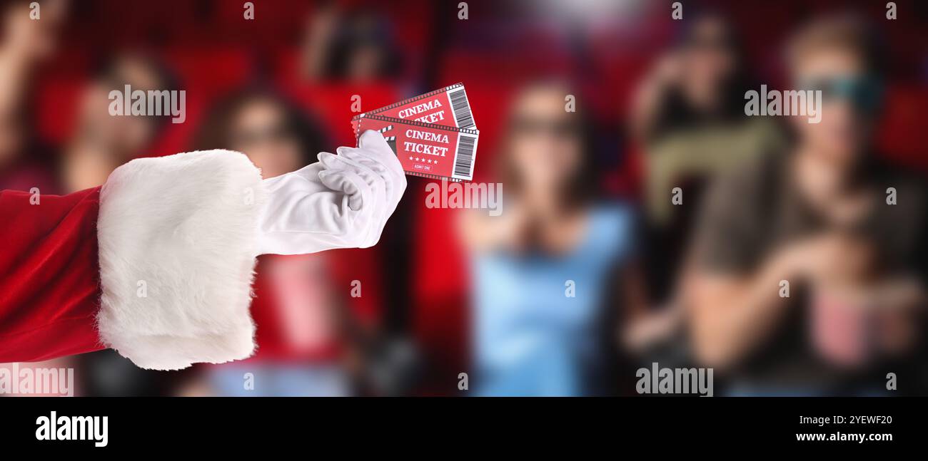 Santa with tickets in cinema. Christmas movie concept Stock Photo - Alamy
