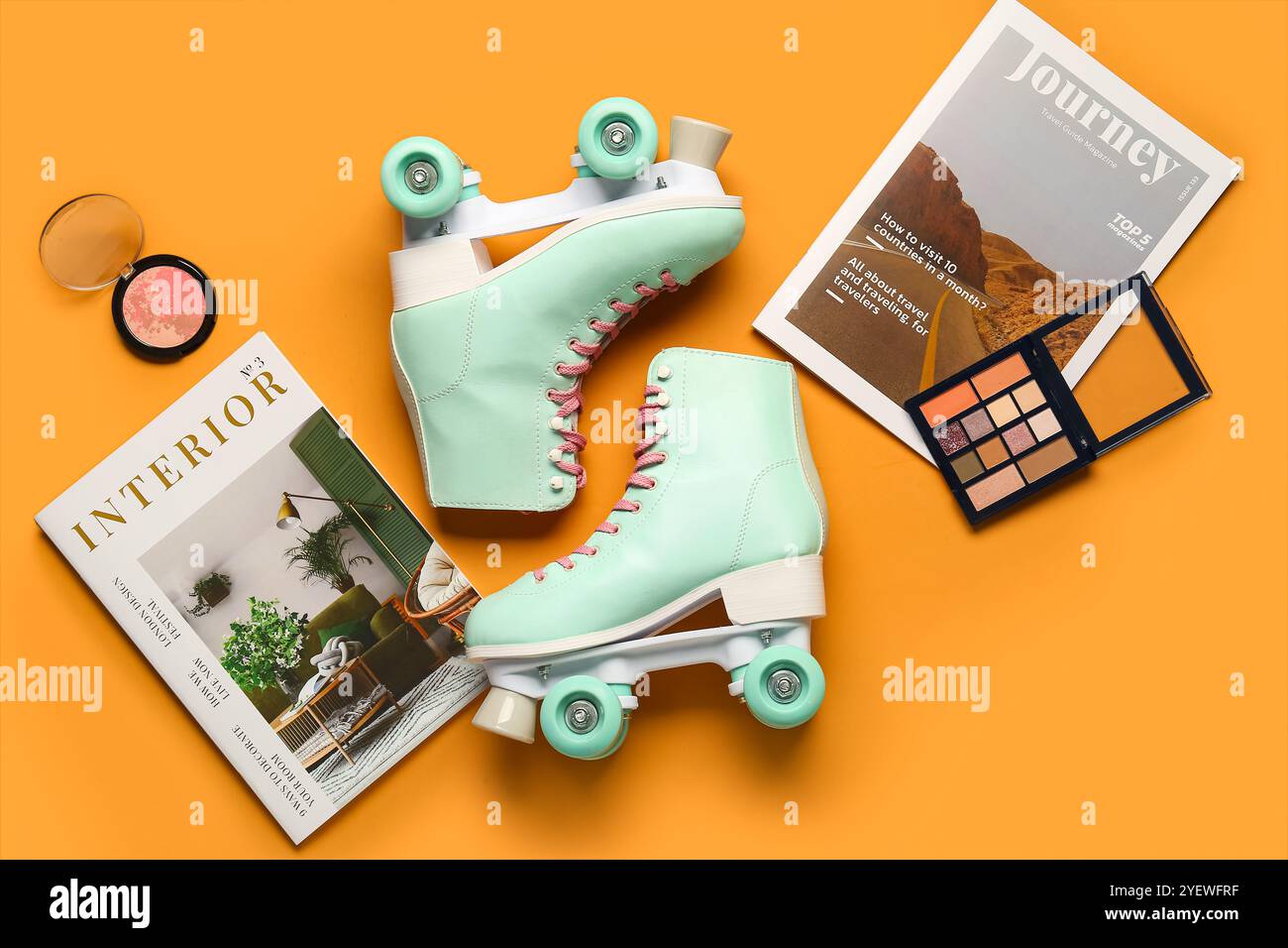 Composition with pair of vintage roller skates, magazines and cosmetic ...