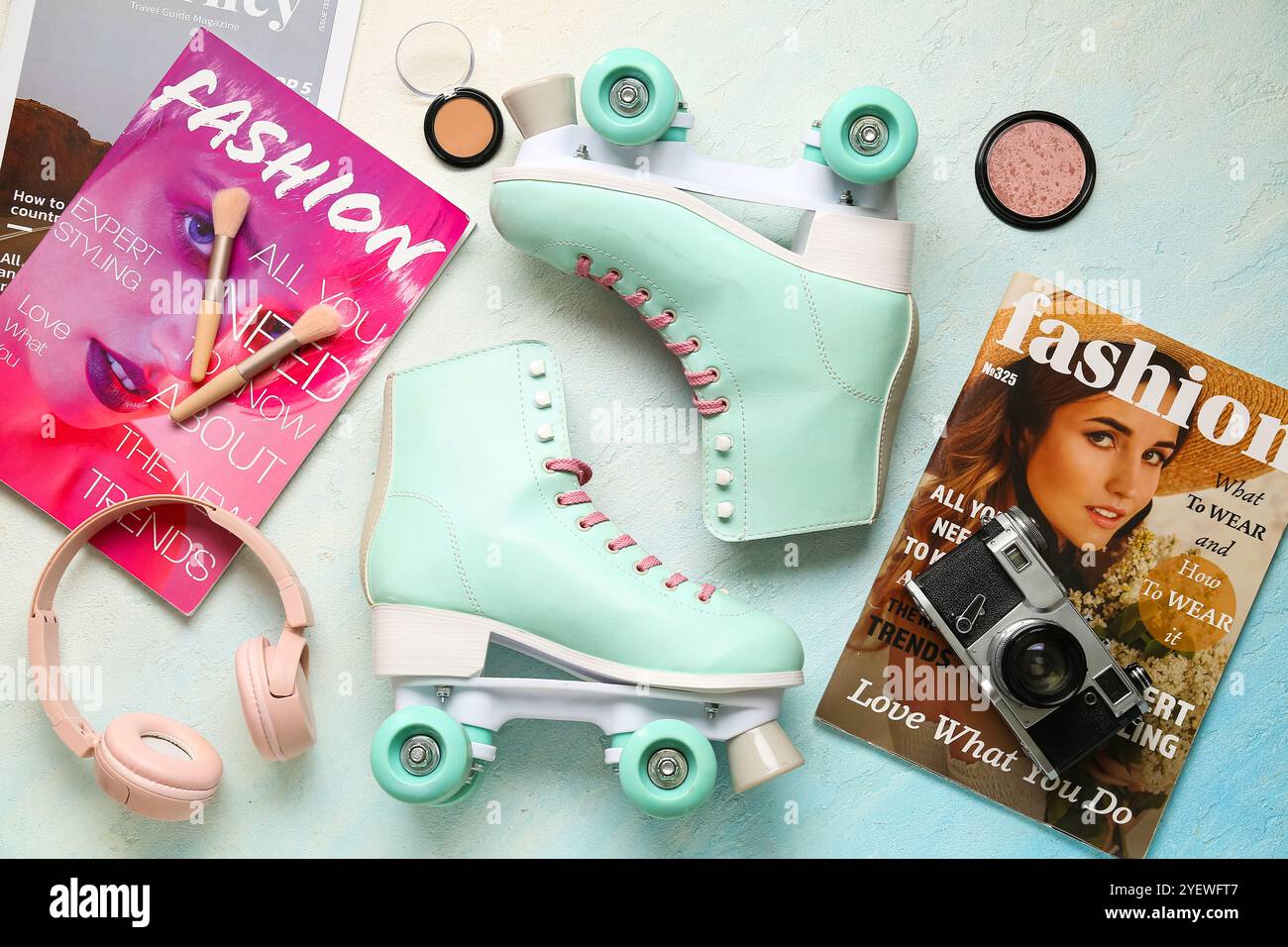 Composition with pair of vintage roller skates, magazines, modern ...