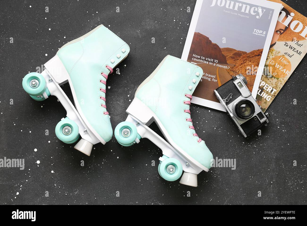 Composition with pair of vintage roller skates, magazines and photo ...