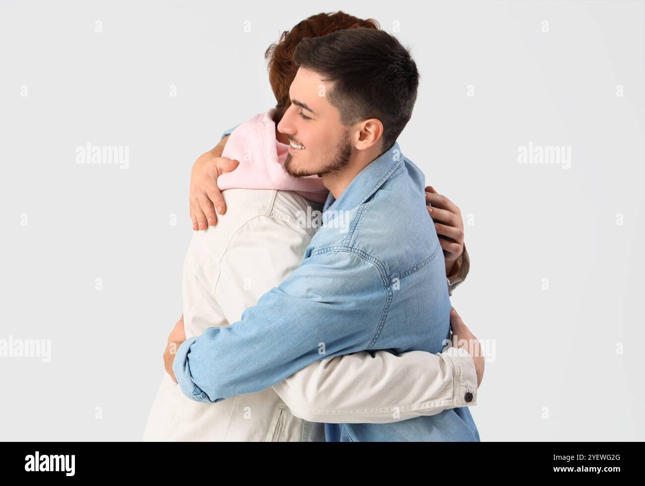 Male friends hugging on white background Stock Photo - Alamy