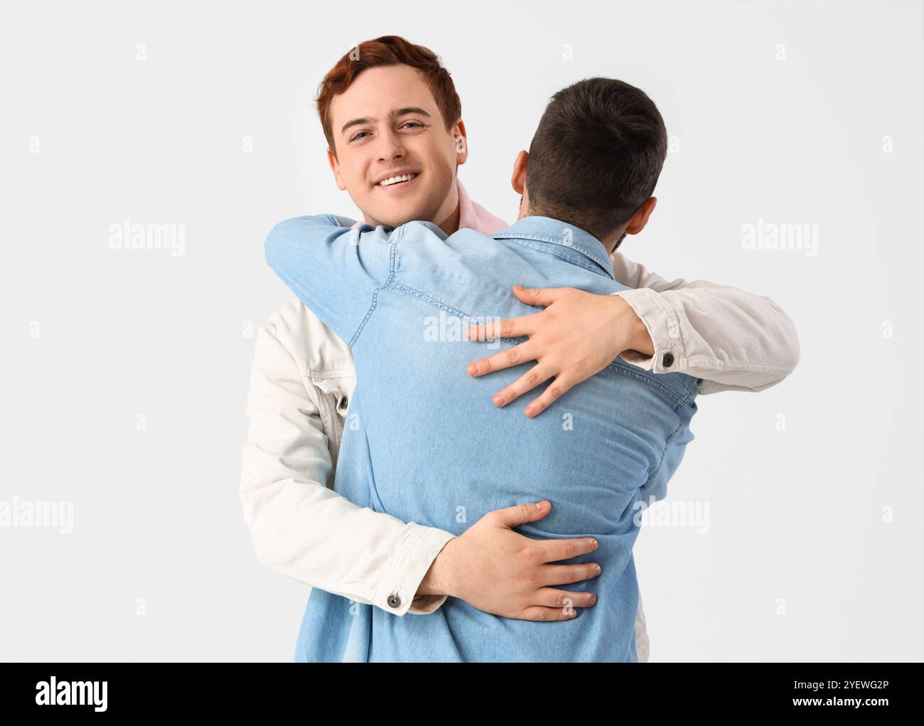 Male friends hugging on white background Stock Photo - Alamy