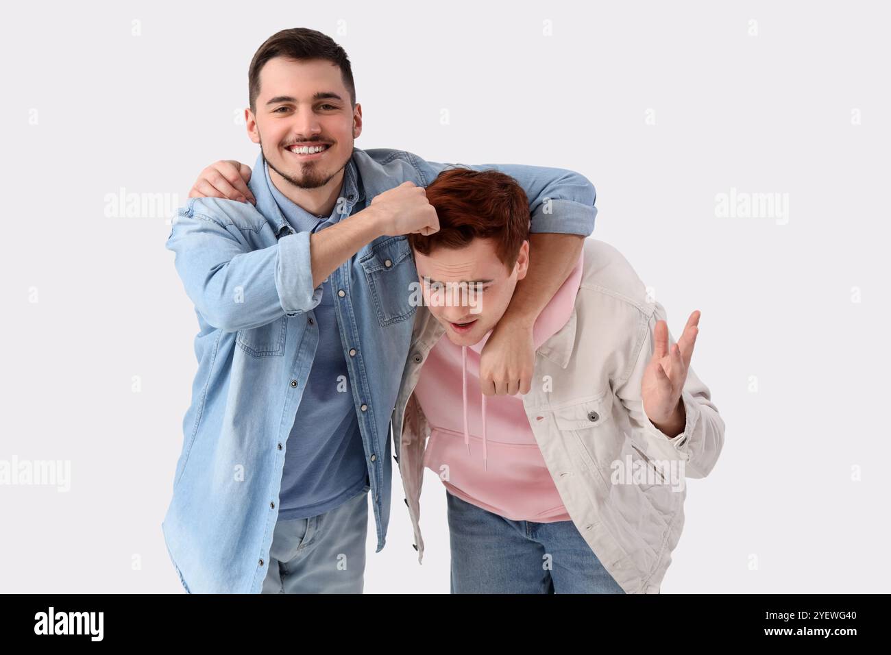 Male friends hugging on white background Stock Photo - Alamy