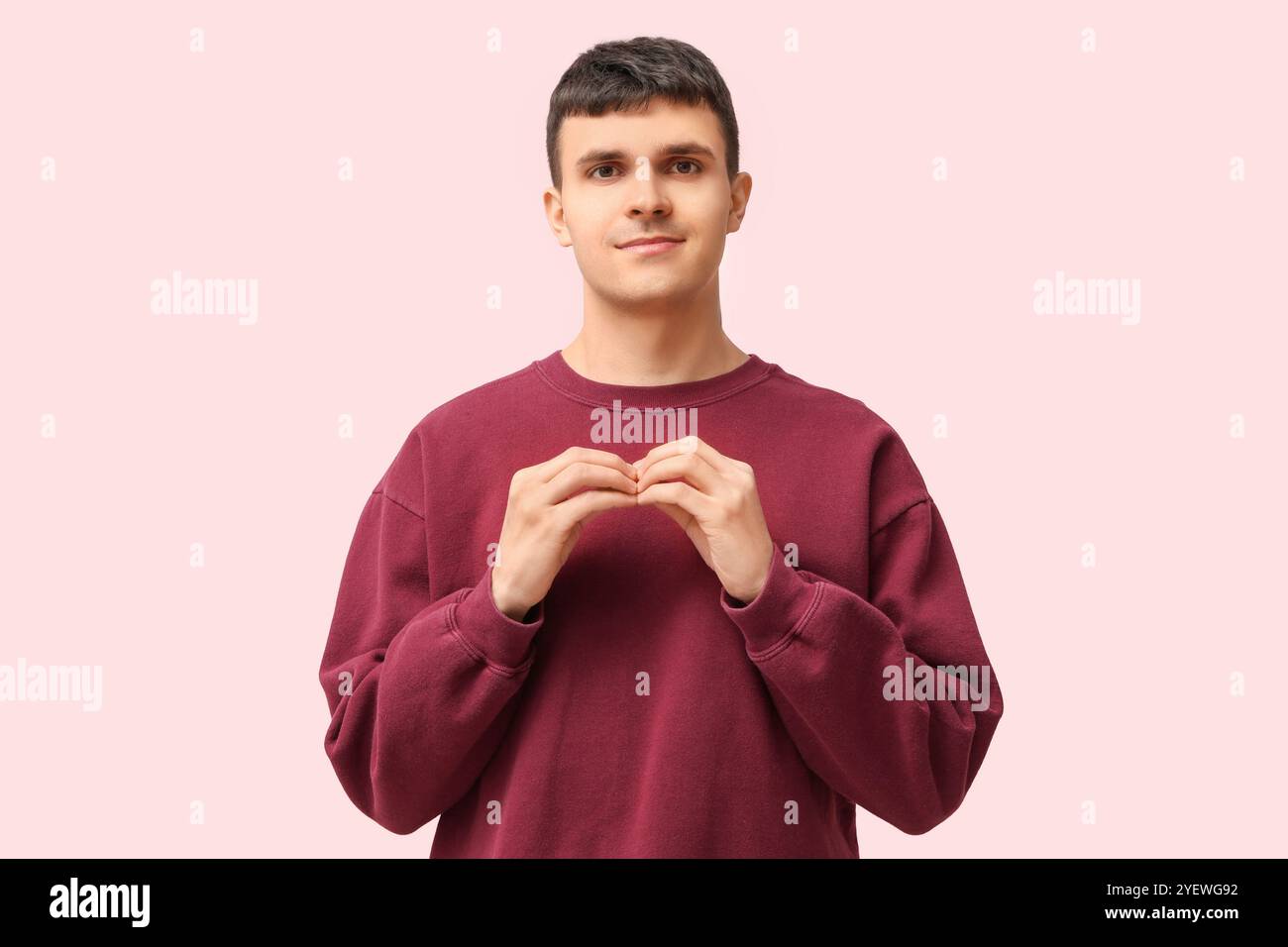 Young deaf mute man using sign language on pink background Stock Photo ...