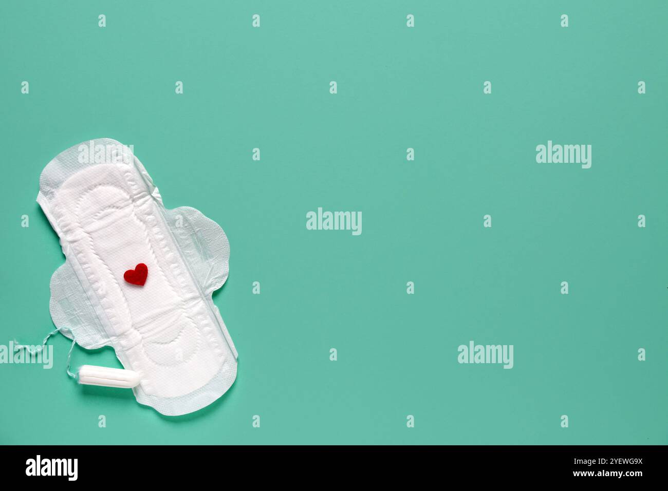 Menstrual pad with red heart and tampon on turquoise background Stock ...