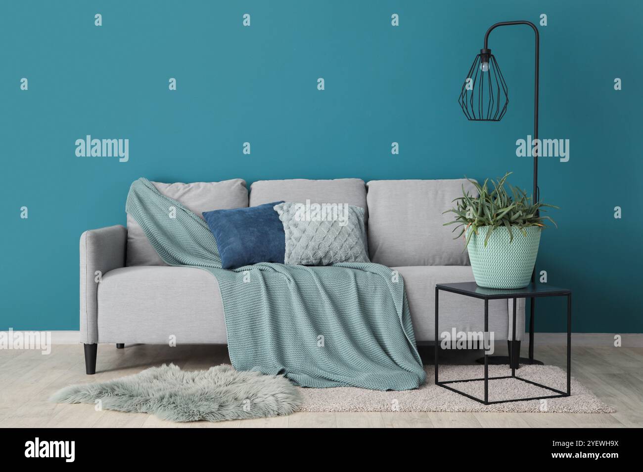 Interior of living room with lamp, sofa and table Stock Photo - Alamy